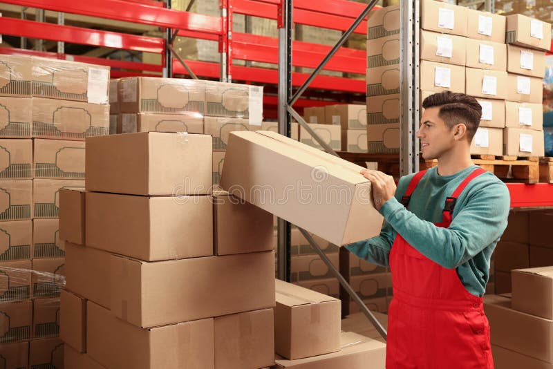 Worker Stacking Cardboard Boxes in Warehouse. Wholesaling Stock Image ...