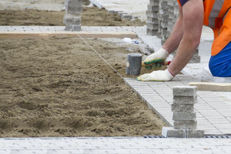 Worker Stacks Paving Slabs by Means of the Mallet Stock Image - Image ...