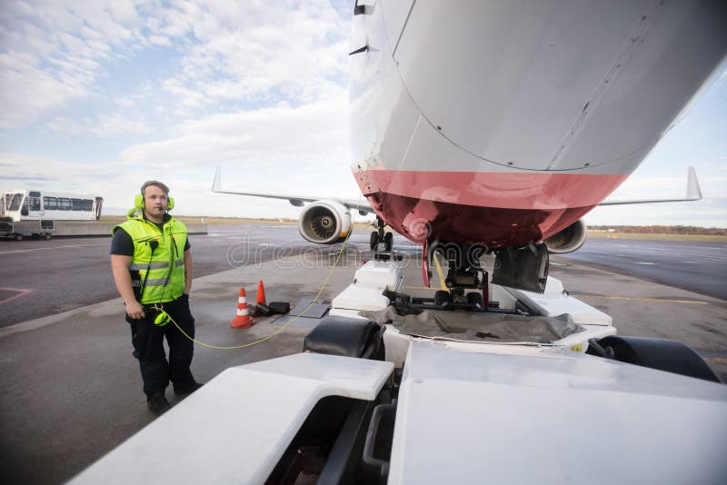 Worker Standing by Airplane with Communication Cable on Runway Stock ...