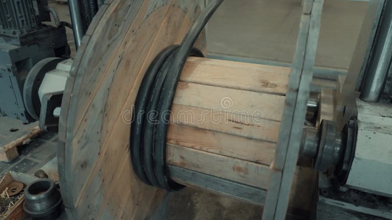 Worker Standing in Front of a Machine Rolling a Cable on a Reel in a ...