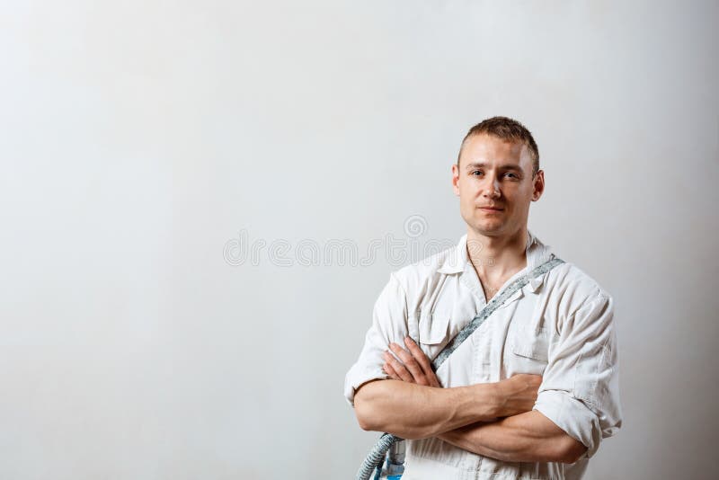 Worker Standing Over White Wall. Copy Space. Stock Photo - Image of ...