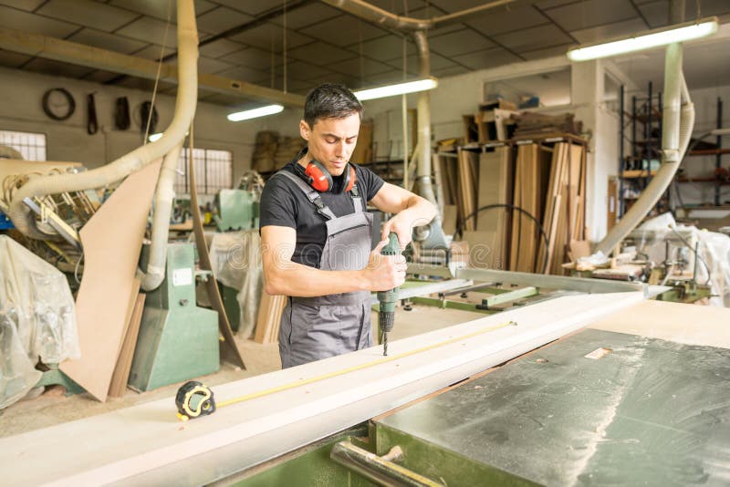Worker Working with a Drill in a Factory Stock Image - Image of ...