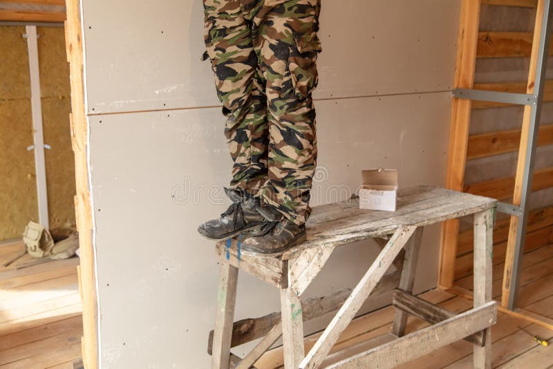 A Worker Stands on a Stepladder at a Construction Site Stock Photo ...