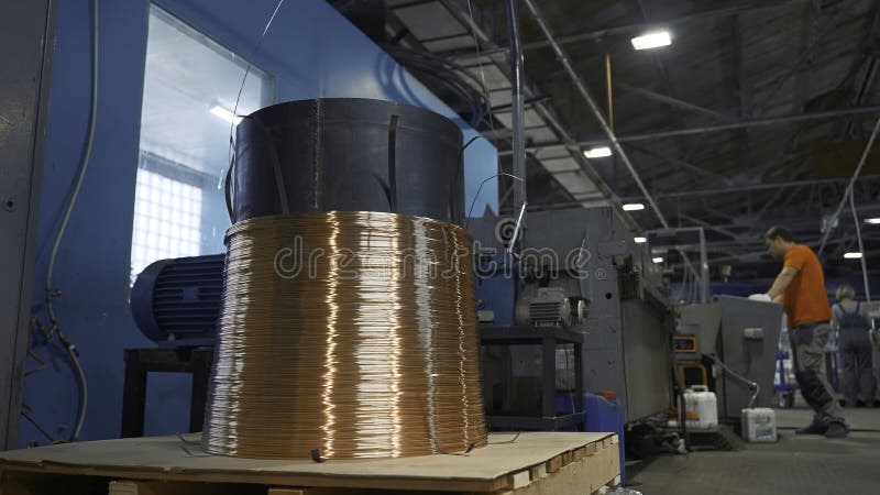 Worker Starts Machine with Copper Wire. Creative. Industrial Cylinder ...
