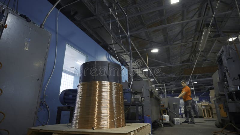 Worker Starts Machine with Copper Wire. Creative. Industrial Cylinder ...