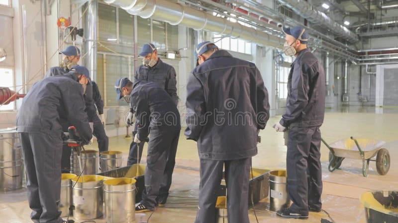Worker Stir Paint in a Bucket. Stirring Paint in a Barrel, Preparing ...