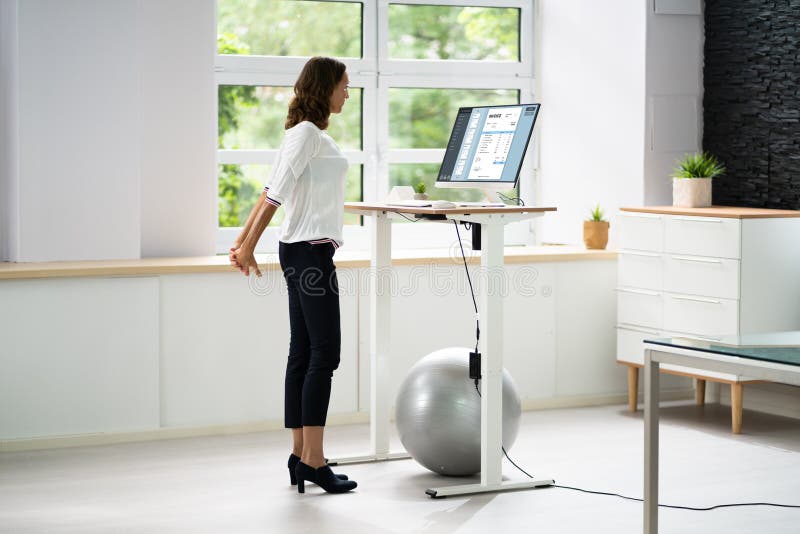 Worker Stretch Exercise at Stand Desk Stock Photo - Image of height ...