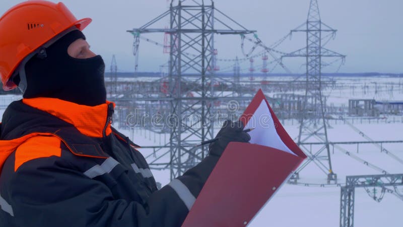 Worker at Substation Checking Documents. Winter Conditions Highlight ...