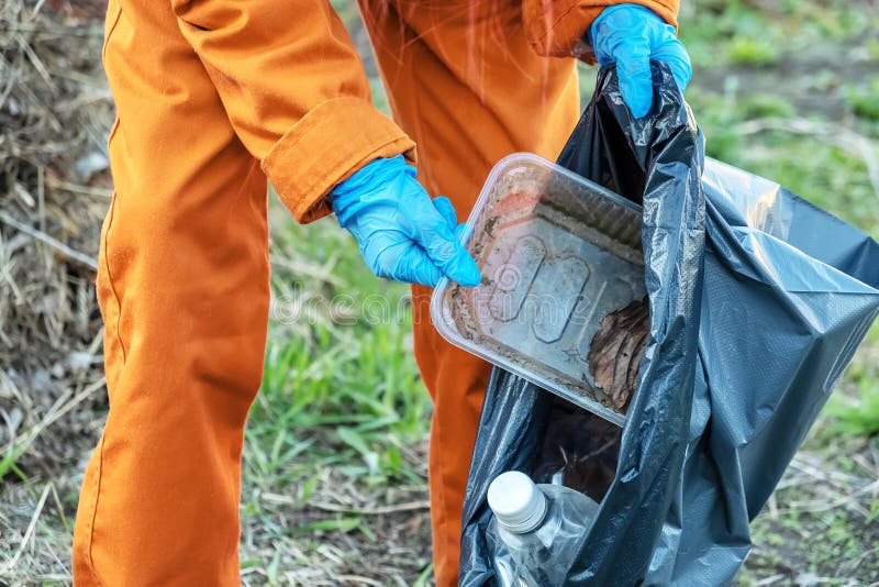 Worker in a Suit Collects Dirty Plastic in a Park Stock Photo - Image ...