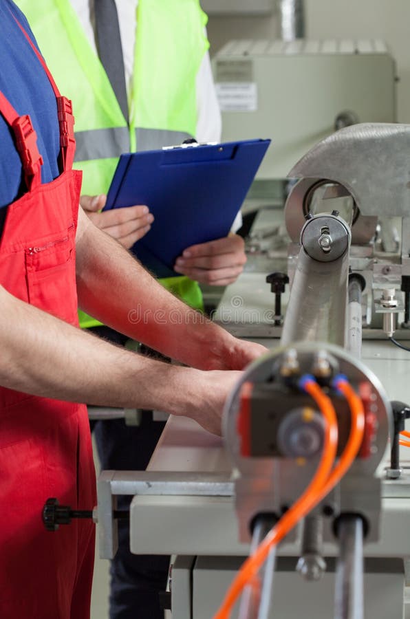 Worker and Supervisor Next To Machine Stock Photo - Image of ...