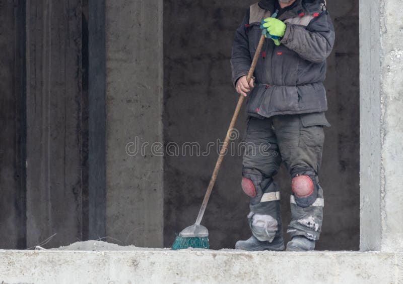 The Worker Sweeps the Garbage at the Construction Site of the House ...
