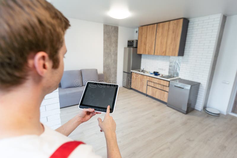 Worker with Tablet Computer Checking Alarm System Indoors. Stock Image ...