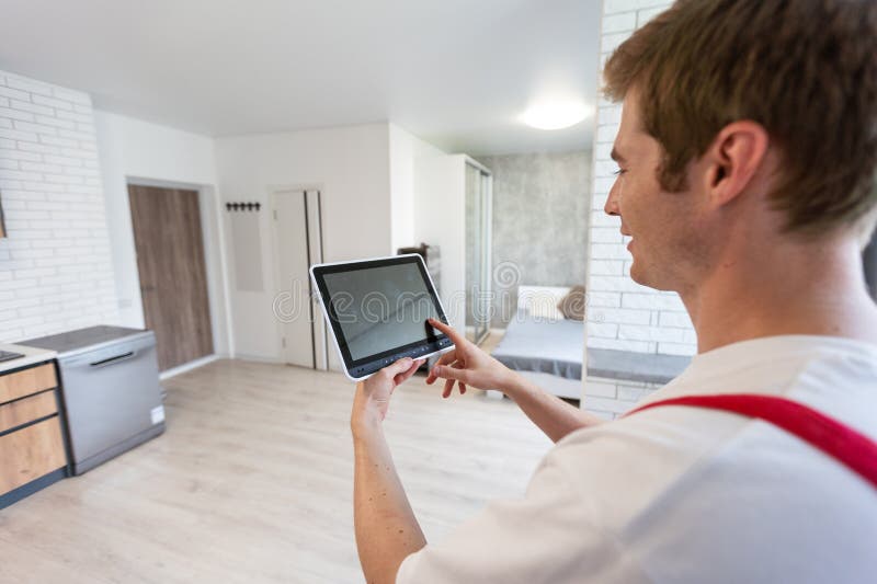Worker with Tablet Computer Checking Alarm System Indoors. Stock Image ...