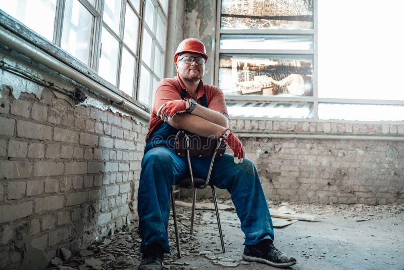 Worker Sitting on a Chair in the Middle of a Construction Site Stock ...