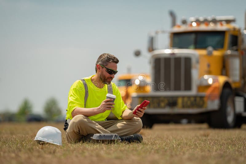 Worker Taking Break from Work Drinking Coffee and Using Phone. Builder ...