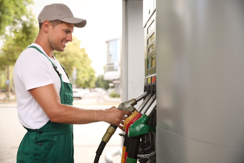 Worker Taking Fuel Pump Nozzle at Modern Gas Station Stock Photo ...