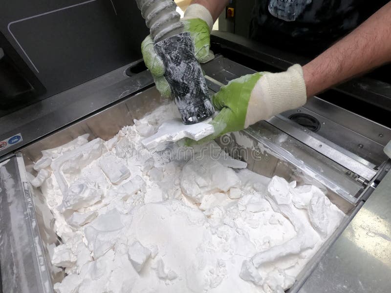 Worker Taking Out Models of White Polyamide Powder and Cleaning Them ...