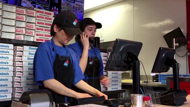 Worker Taking Phone Call for Customer Ordering Domino Pizza Stock ...