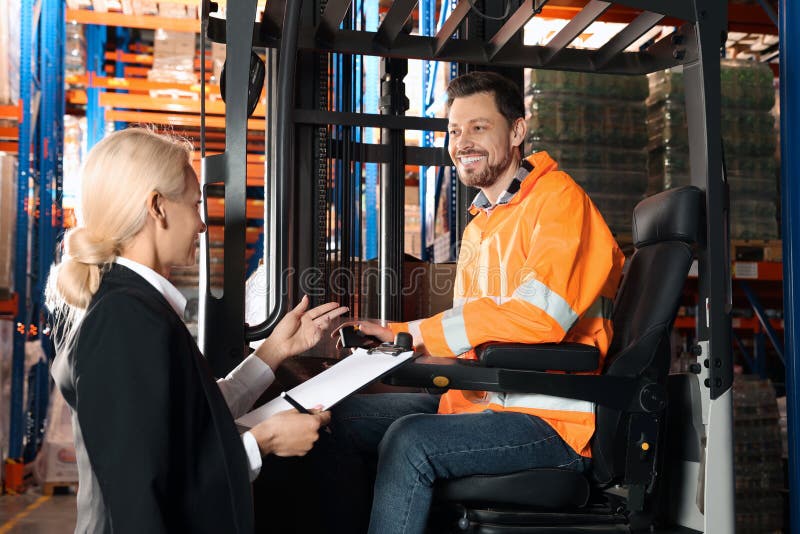 Happy Worker Talking with Manager while Sitting in Forklift Truck at ...