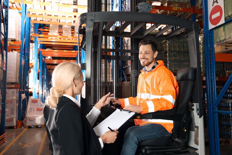 Happy Worker Talking with Manager while Sitting in Forklift Truck at ...