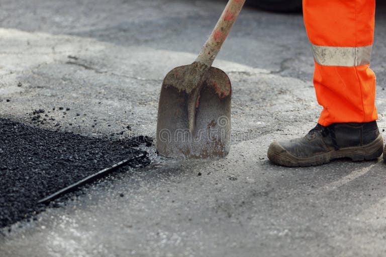 Worker tarmacking road stock image. Image of levelling - 14750153