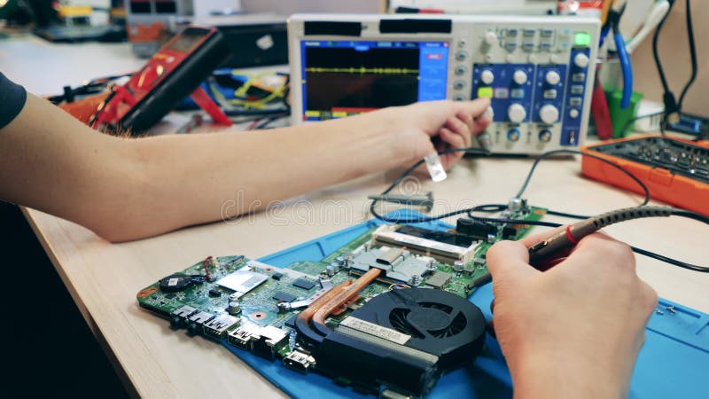 Worker Testing Laptop Motherboard Using Oscilloscope Stock Footage ...