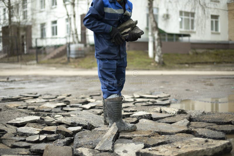 Worker Throws Rocks at Road. Bad Road Repairs Stock Photo - Image of ...