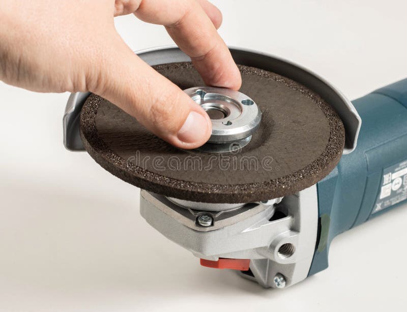 The Worker Tightens the Clamping Nut on the Grinding Wheel in the ...