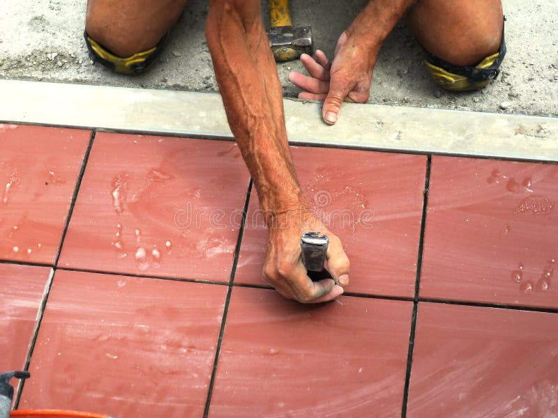 Elderly Person Intent on Instiling and Linear Tiles Stock Image - Image ...