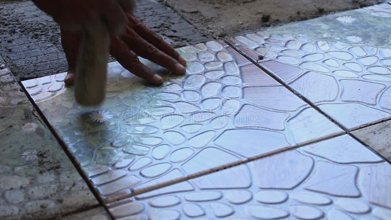 Flooring and Tiling. Professional Tiler Placing Floor Tiles on Adhesive ...