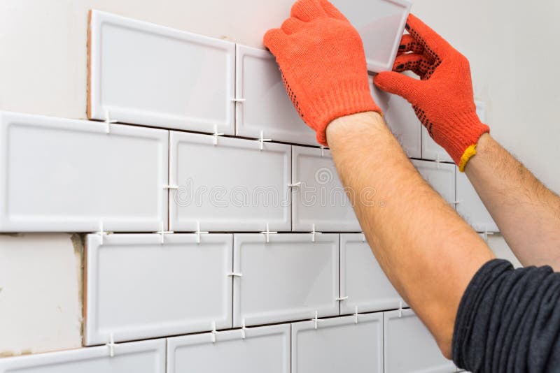 Worker tiling wall stock photo. Image of alignment, tiler - 670924
