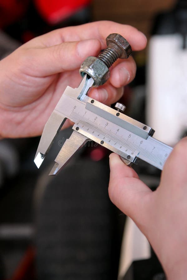 Worker with Tools in Hands. Mechanic is Checking and Measuring Size ...