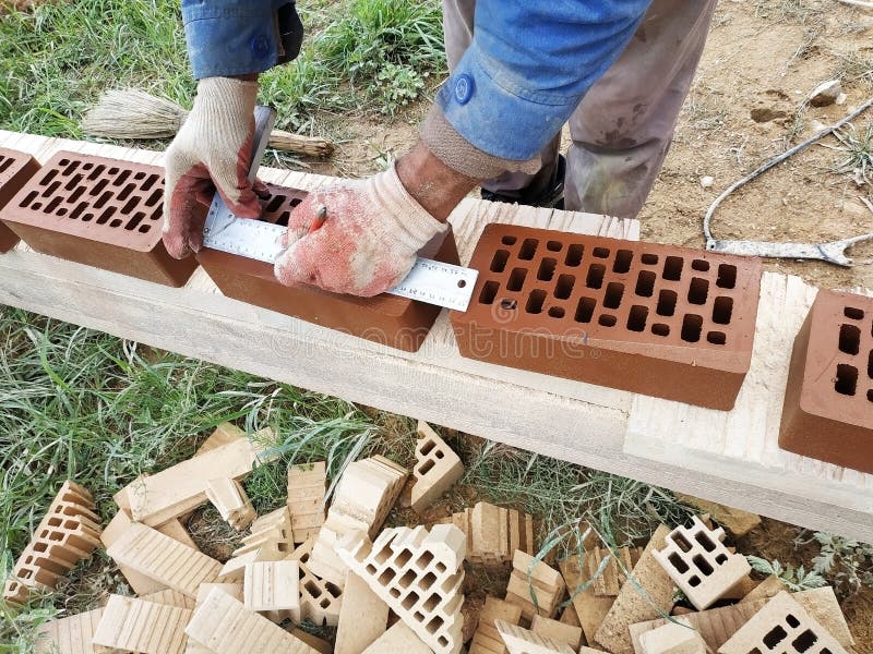 The Worker Translates the Facade Bricks for Further Measurement and ...