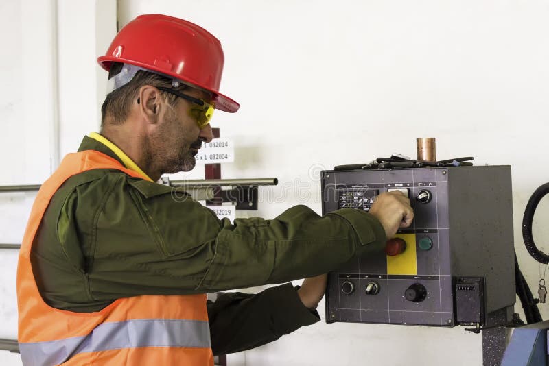 Worker turning on machine stock photo. Image of worker - 47177302