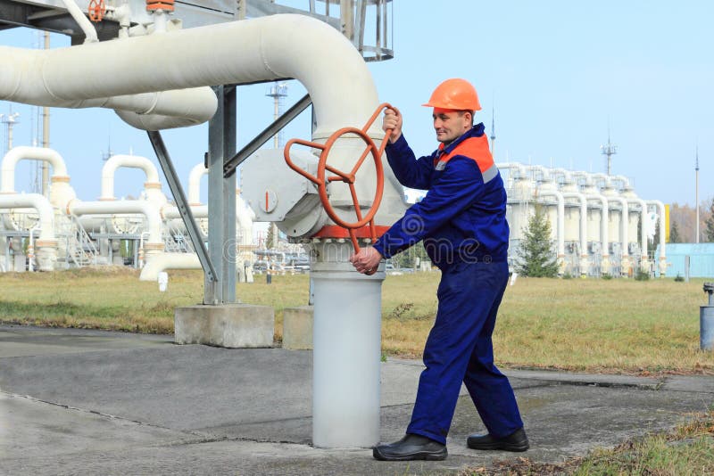 Worker turns valve stock image. Image of outside, human - 47463751