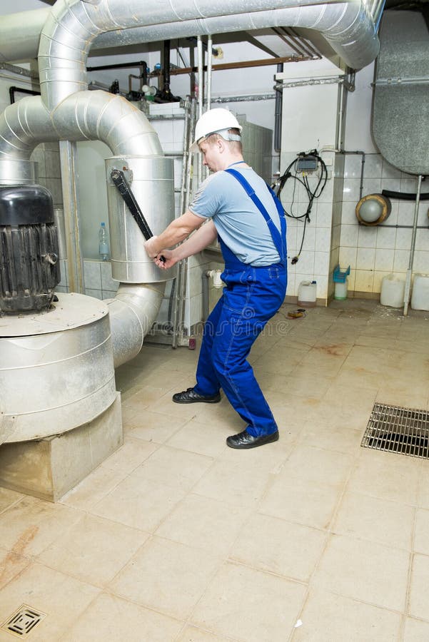 Worker turns a valve stock image. Image of service, silver - 35881341