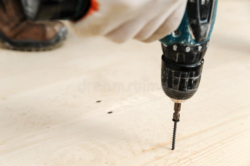 Worker Twisting into the Floor Board. Stock Photo - Image of wood ...