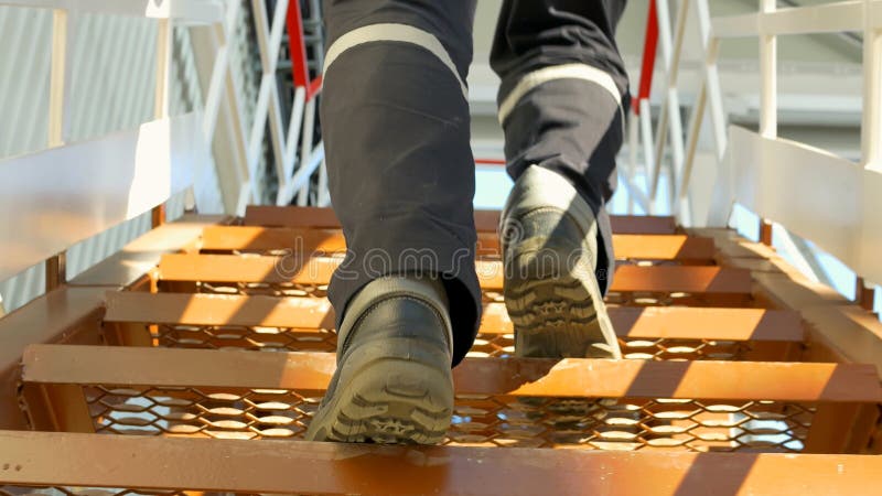 Worker Uniform Ascends Iron Ladder, Industrial Technology. Human Labor ...