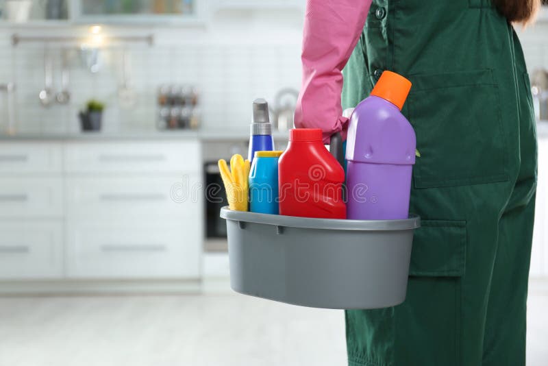 Worker in Uniform with Basin of Detergents in Kitchen. Cleaning Service ...