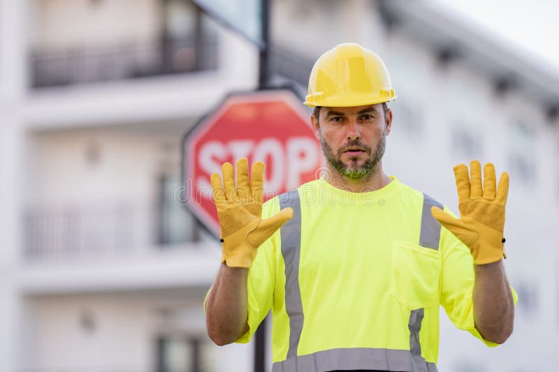 Worker in Uniform Gesturing Stop. Builder with Stop Road Sign Stock ...