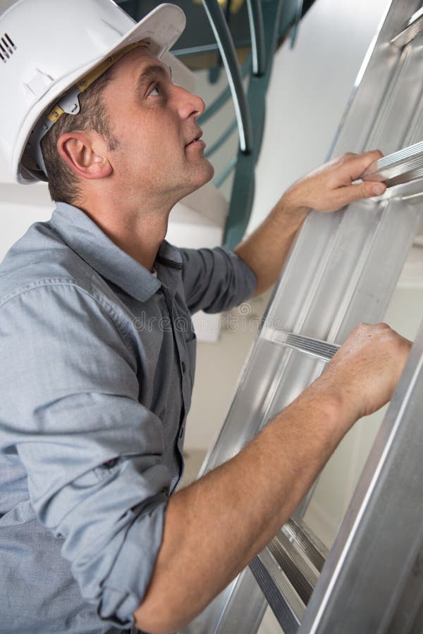 Worker in Uniform Going Up Ladder Stock Photo - Image of closeup ...
