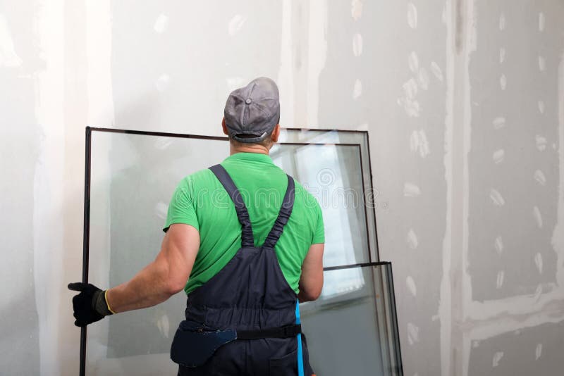 Worker in Uniform Holding Double Glazing Window Indoors, Back View ...