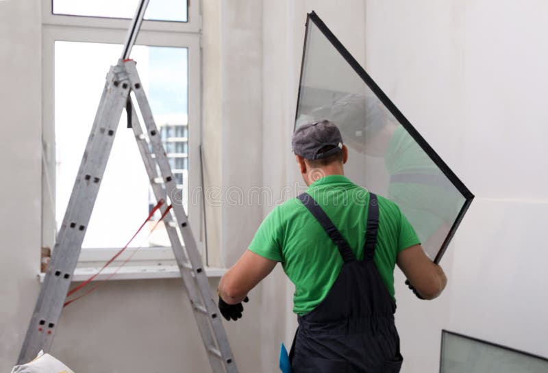 Worker in Uniform Holding Double Glazing Window Indoors, Back View ...