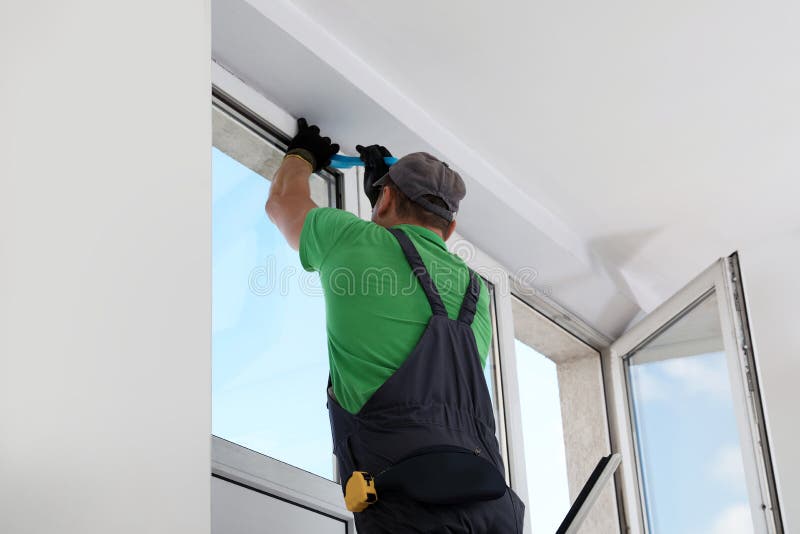 Worker in Uniform Installing Window Indoors, Back View Stock Photo ...