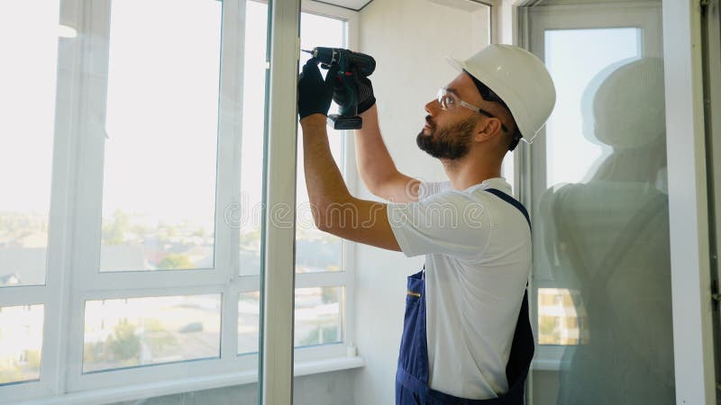 Worker in Uniform Installing Window with Power Drill Stock Footage ...