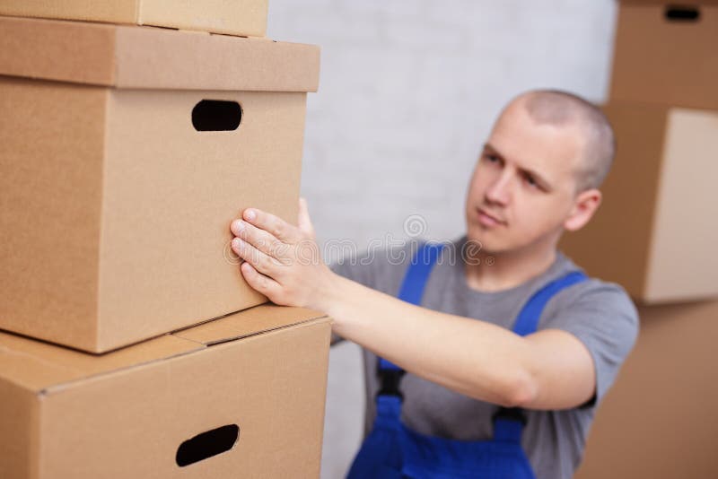 Worker in Uniform Taking Big Box from Shelf in Warehouse Stock Photo ...