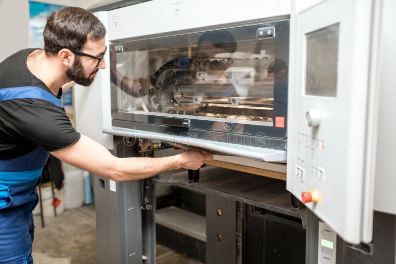 Man Working with Printing Machine at the Manufacturing Stock Photo ...