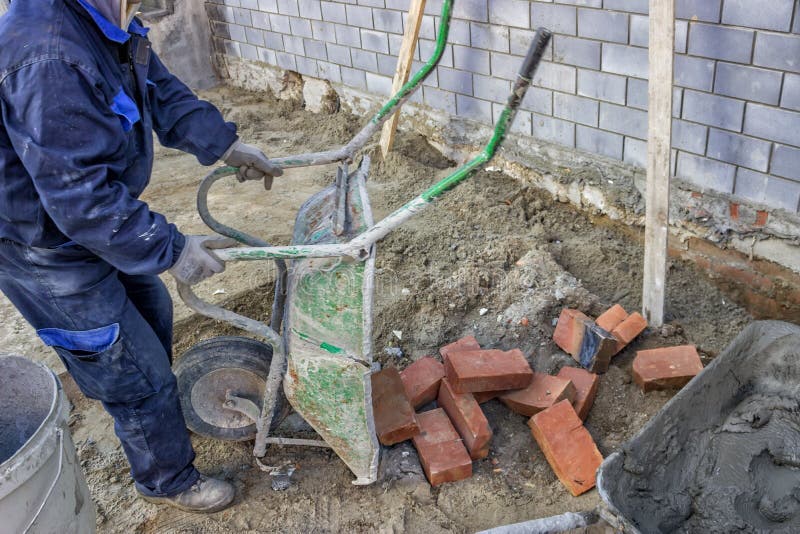Worker Unload a Wheelbarrow with Bricks 2 Stock Image - Image of ...