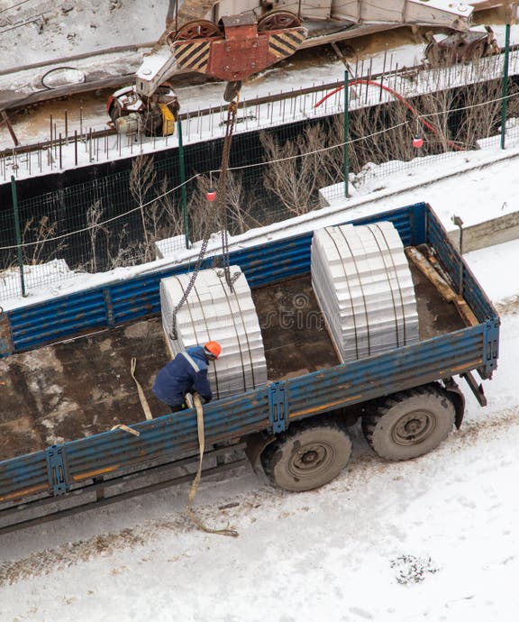 A Worker is Unloading Bricks in a Truck at a Construction Site Stock ...