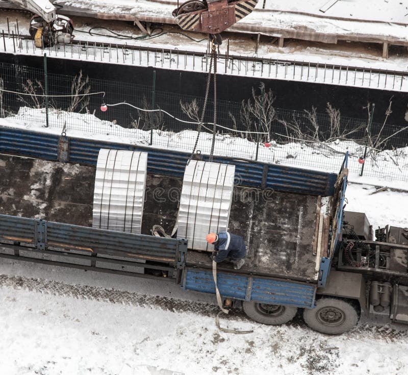 A Worker is Unloading Bricks in a Truck at a Construction Site Stock ...